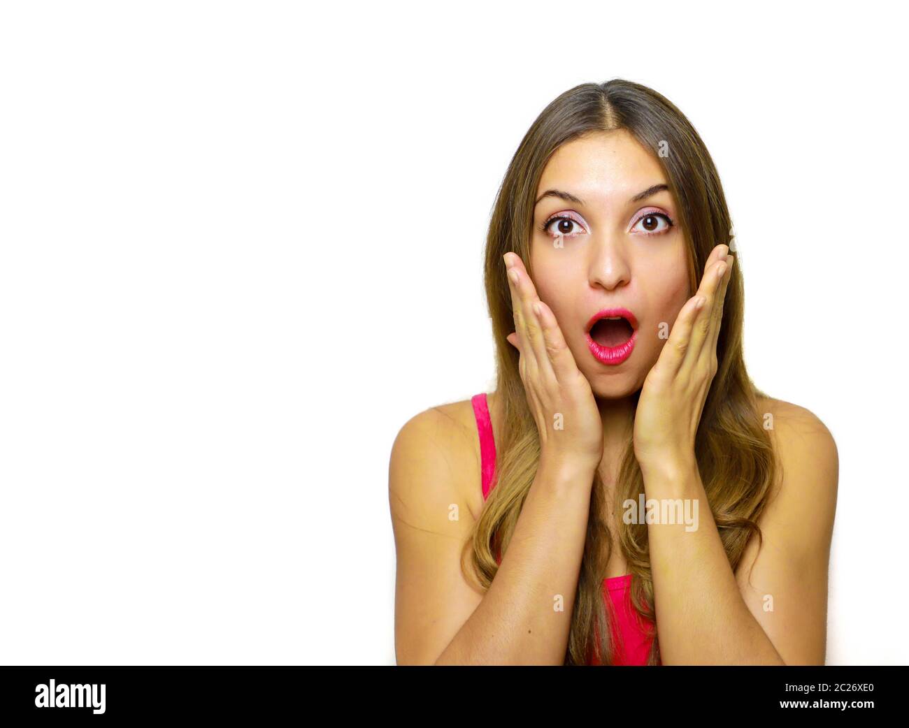 Surprised young woman shouting over white background. Looking at camera ...