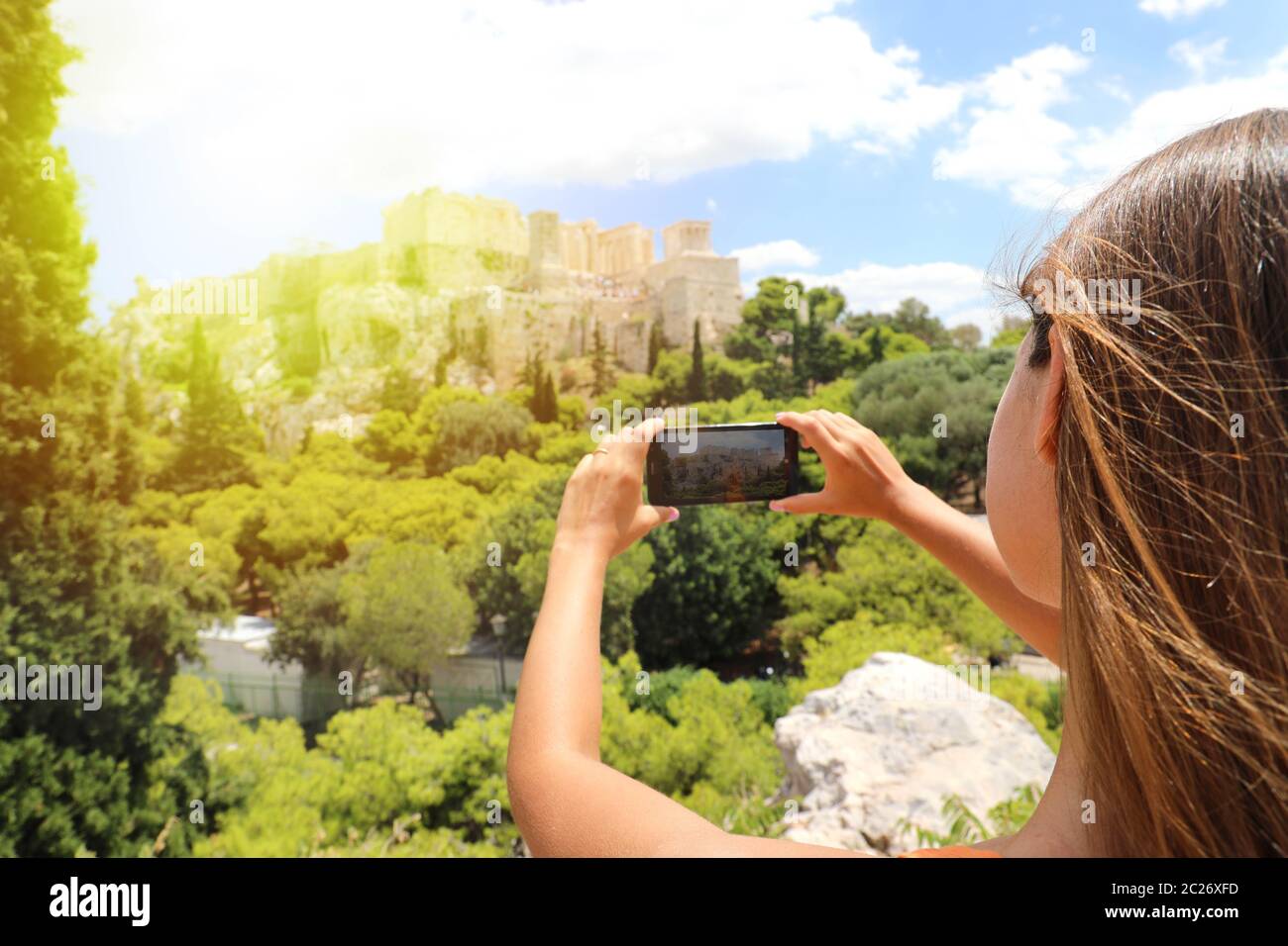 Cute young woman takes a picture of the Acropolis, Athens, Greece ...