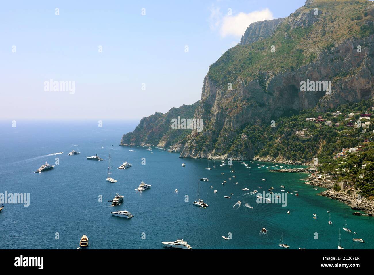 Spectacular view of Capri rocky coast with yatchs and luxury ships in ...