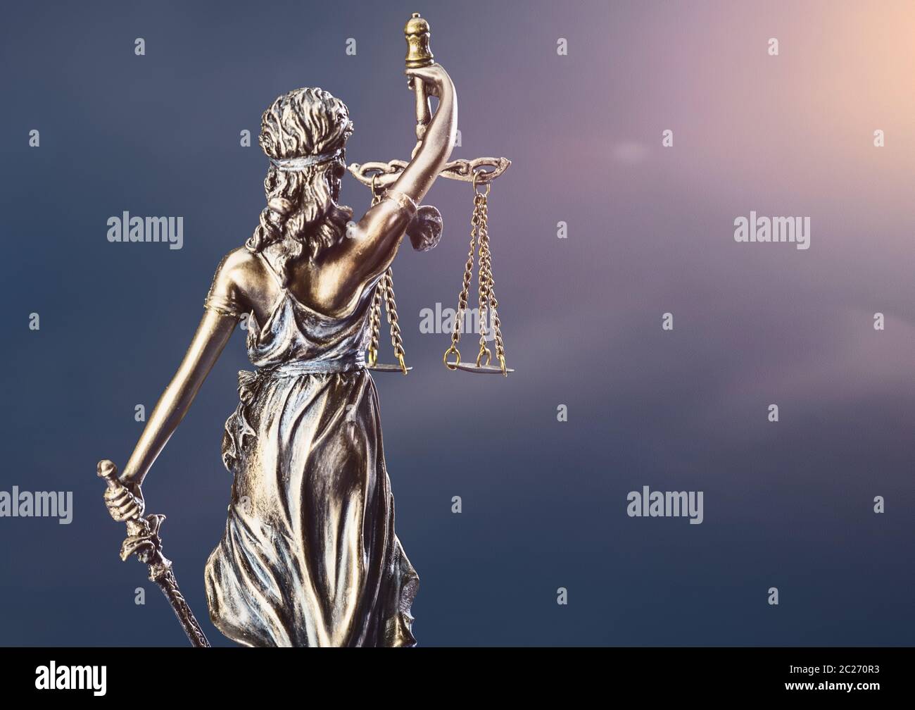 Statue of lady justice on dark background - rear view with copy space ...