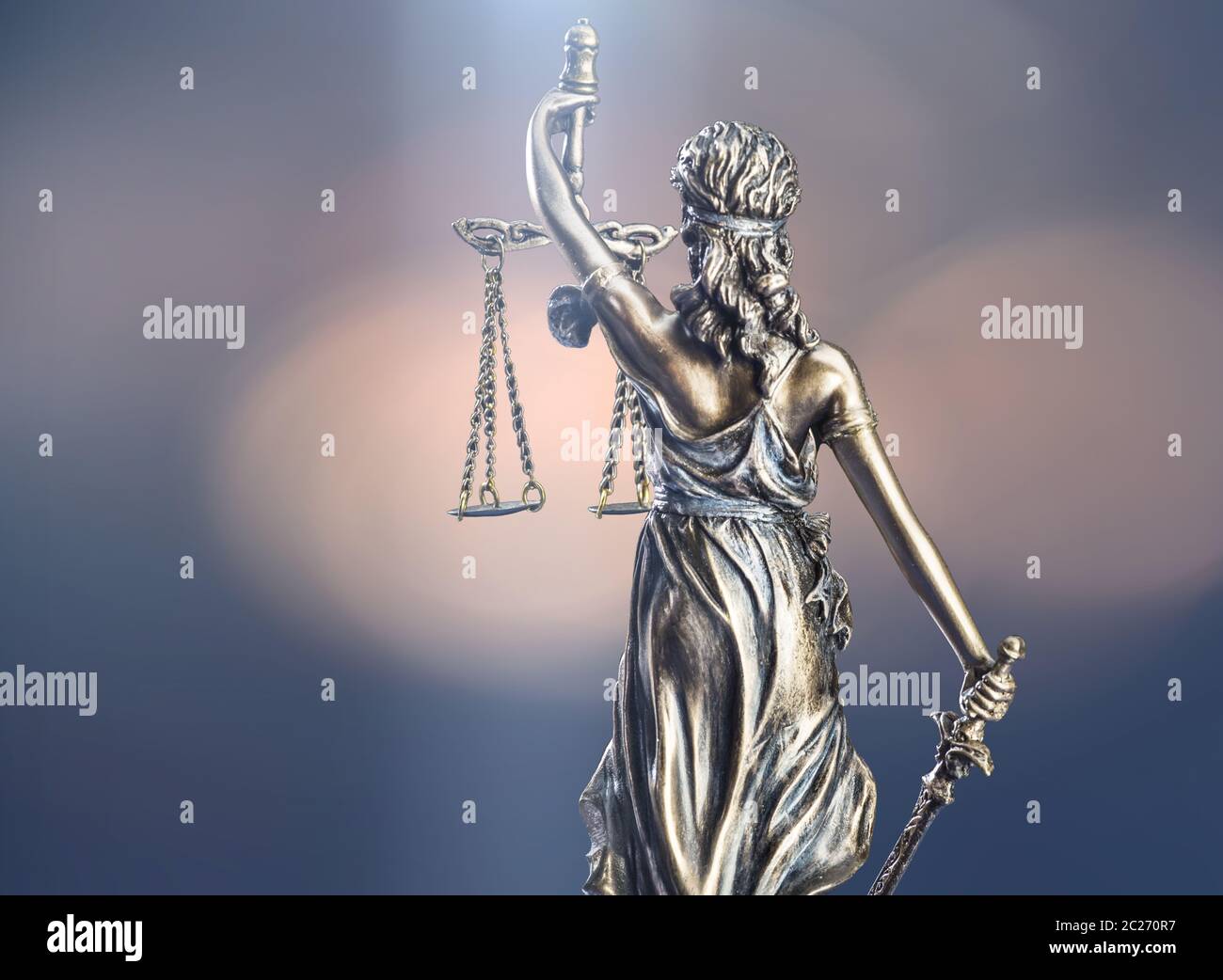 Statue of lady justice on dark background - rear view with copy space ...