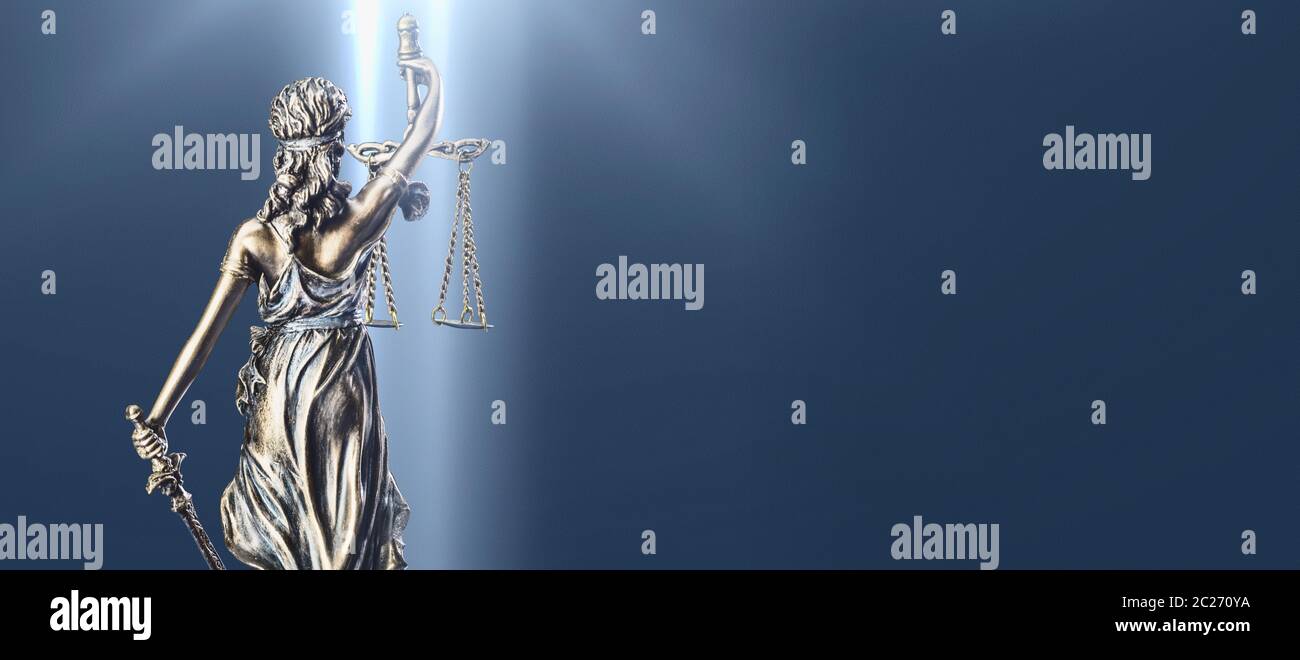 Statue of lady justice on dark background - rear view with copy space ...