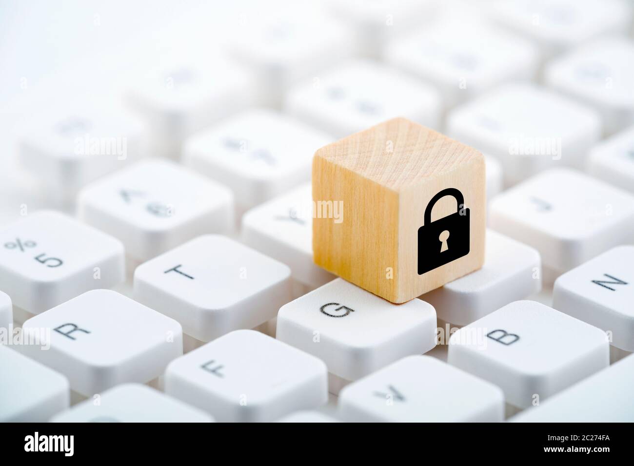 Wooden block with lock graphic on computer keyboard. Computer security ...