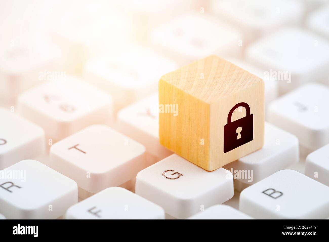 Wooden block with lock graphic on computer keyboard. Computer security ...