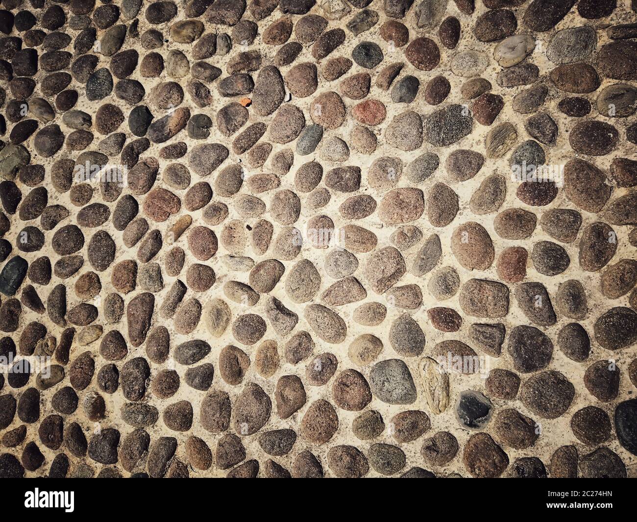 Color image of a pavement made of round stones Stock Photo - Alamy