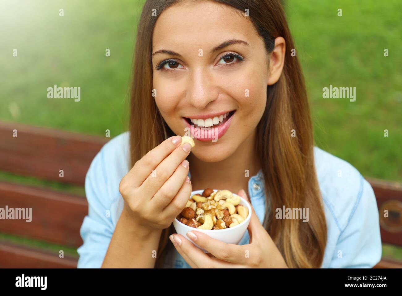 Woman eating peanuts hi-res stock photography and images - Alamy