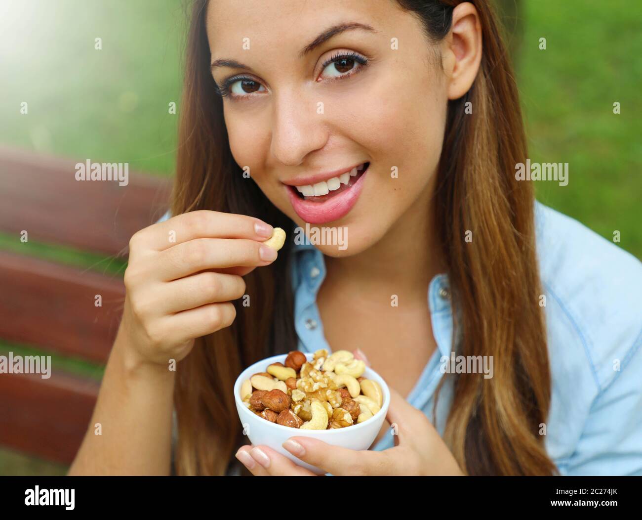 Woman eating peanuts hi-res stock photography and images - Alamy