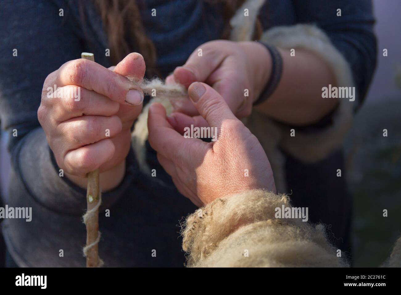the hands that spin wool fleece by hand Stock Photo - Alamy