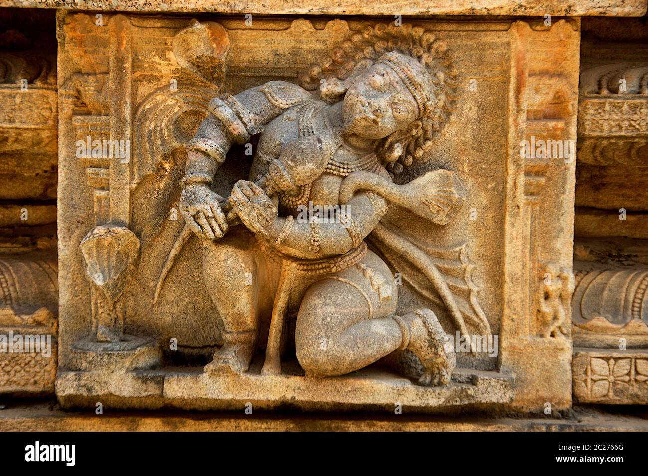 Close-up of stone sculpture of bean player on wall at Rayara Gopura in ...