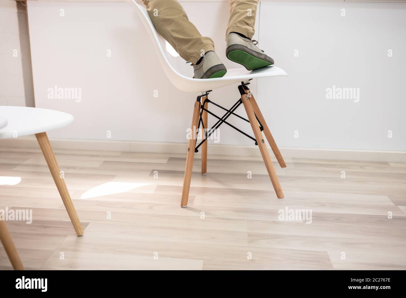 Man Standing On Chair And About To Fall On Floor Stock Photo - Alamy