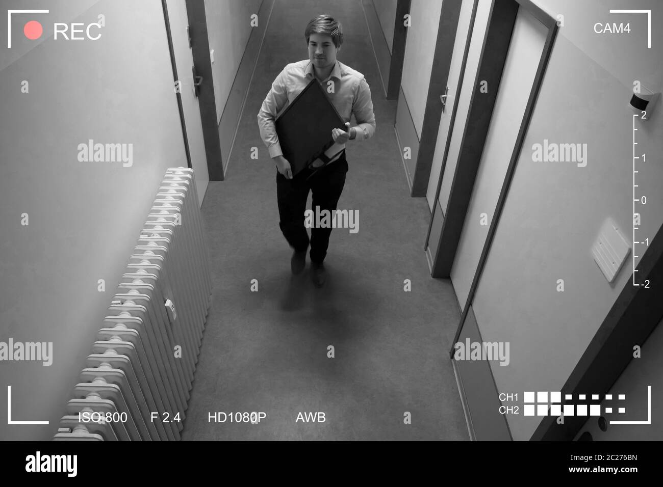 Young Man Stealing Computer Monitor Walking In Corridor Scene Through ...
