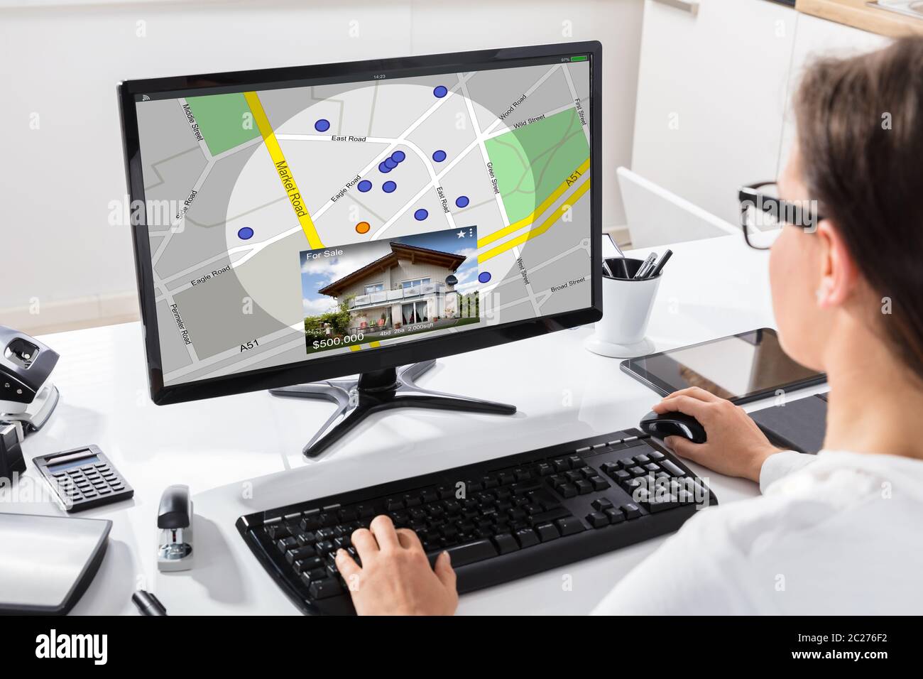 Woman Searching For Real Estate Online On Desktop Computer Stock Photo ...