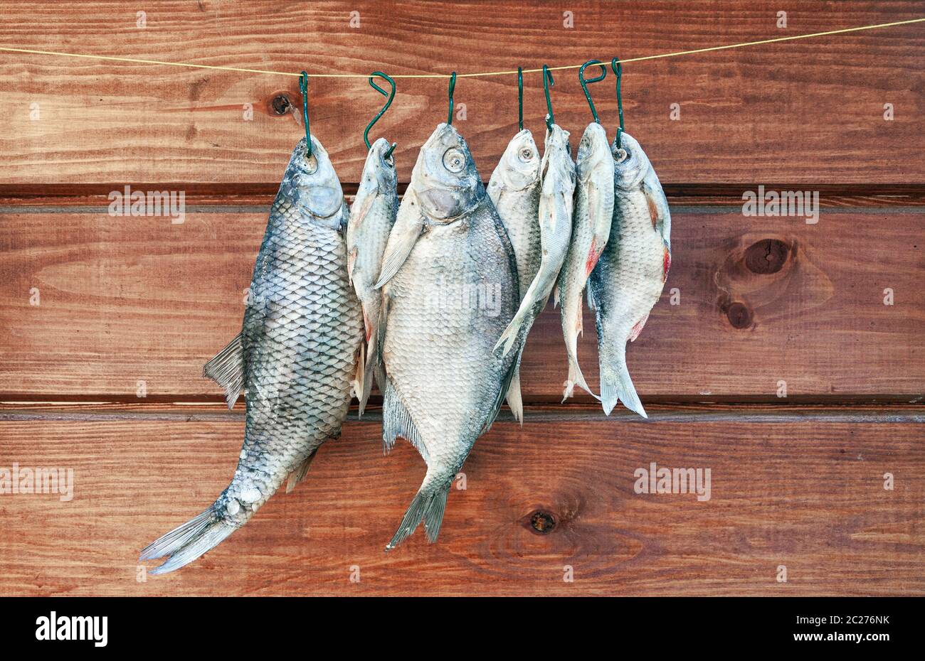 Dried fish hanging on market hi-res stock photography and images - Alamy