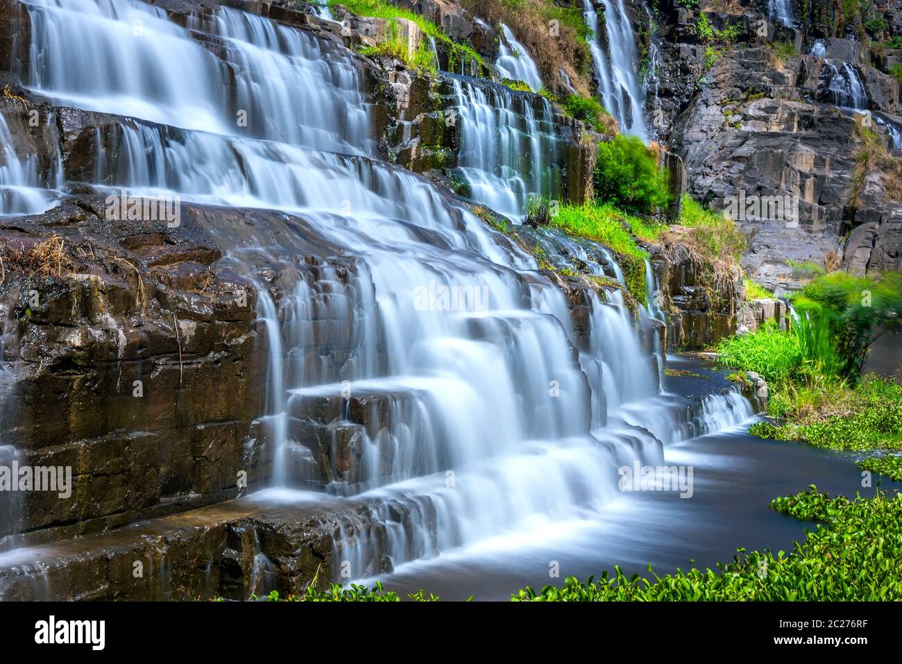 Waterfall early winter afternoon with water flowing over rocks creating ...