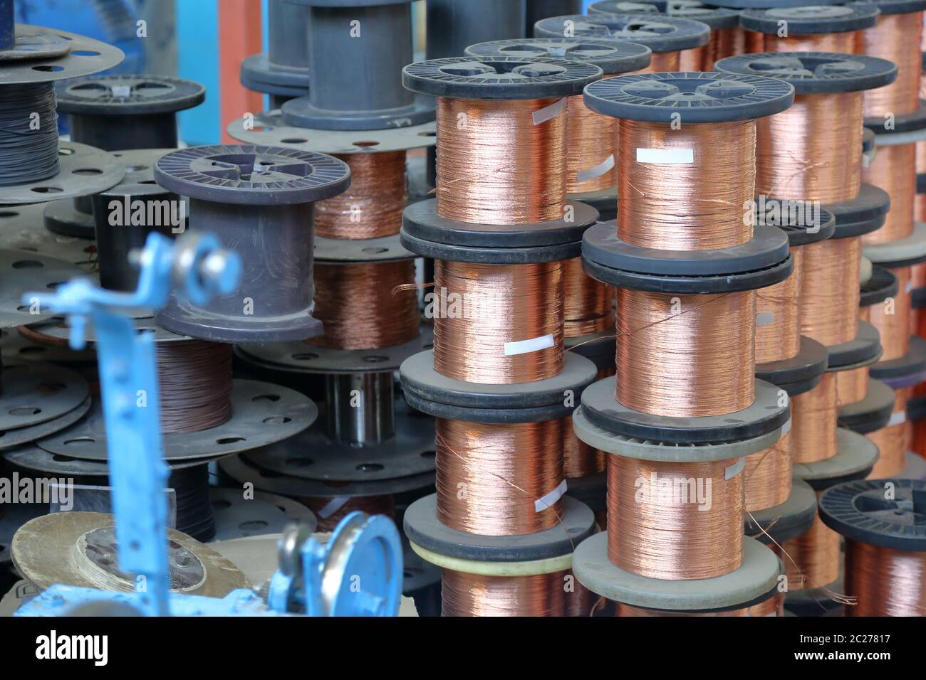 Massive industrial bobbins with twisted copper wire Stock Photo - Alamy