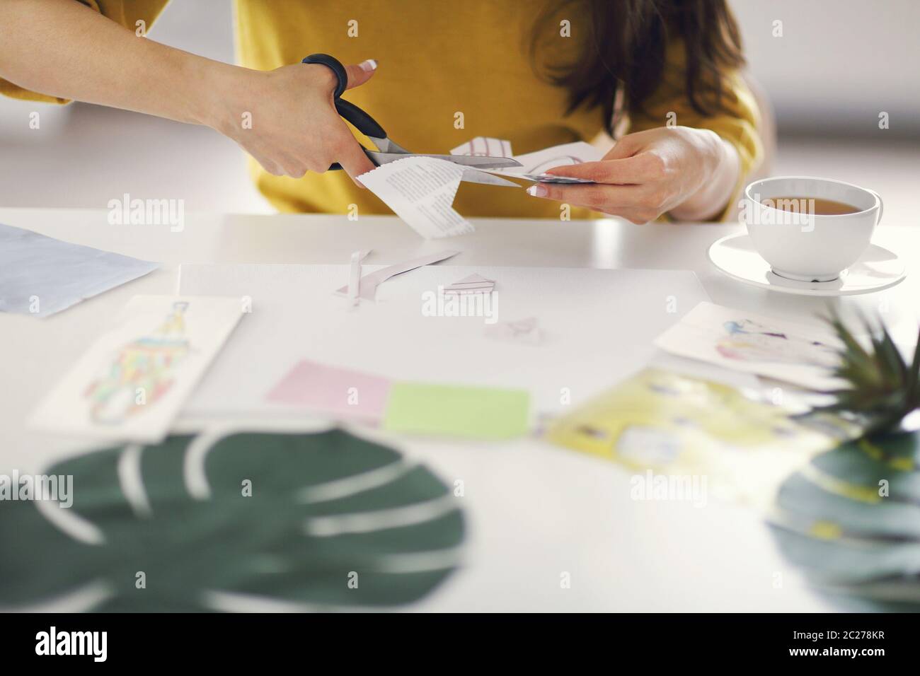 Young brunette woman creating her Feng Shui wish map Stock Photo - Alamy