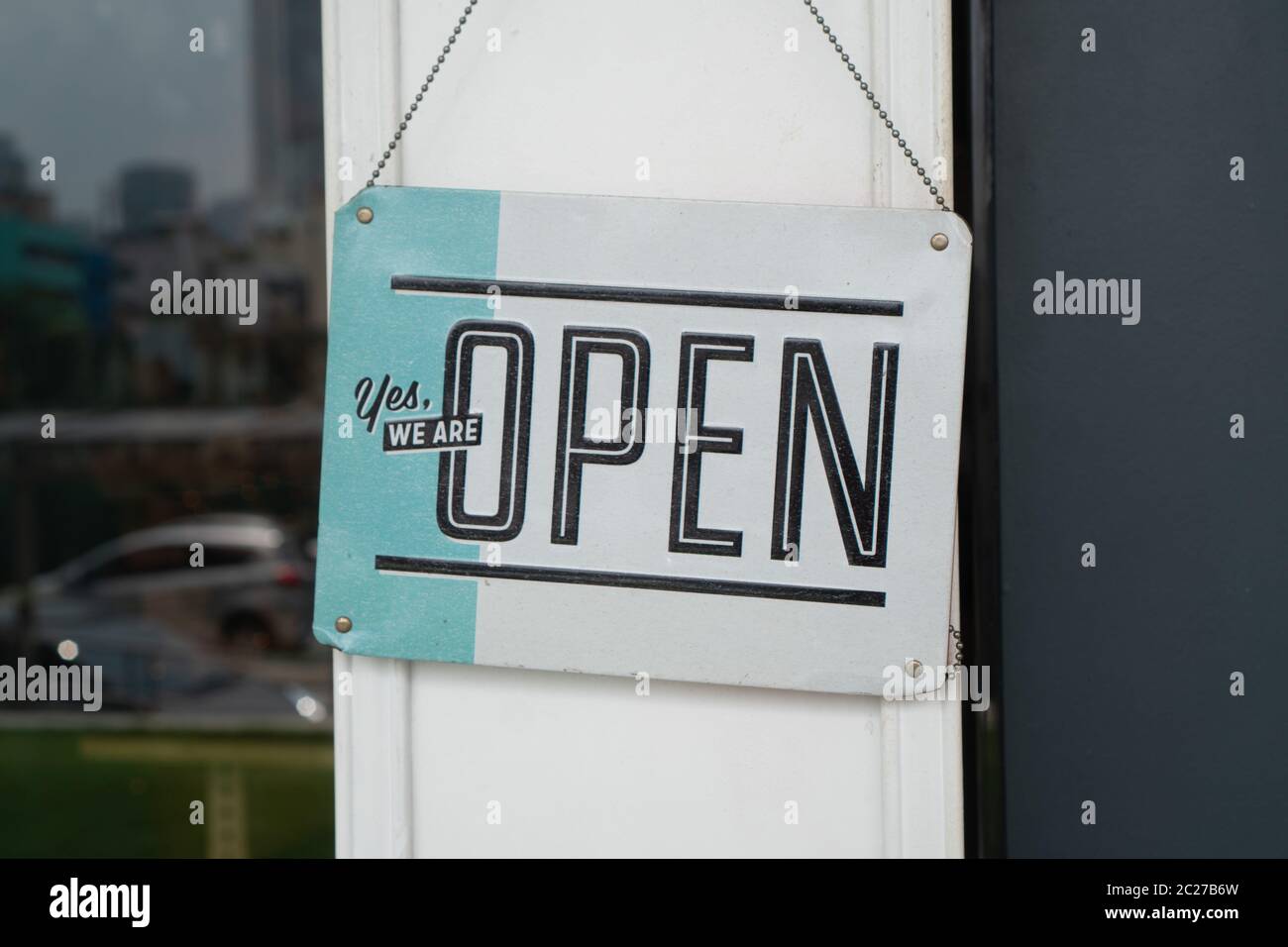 OPEN sign hang on street cafe door at entrance Stock Photo - Alamy