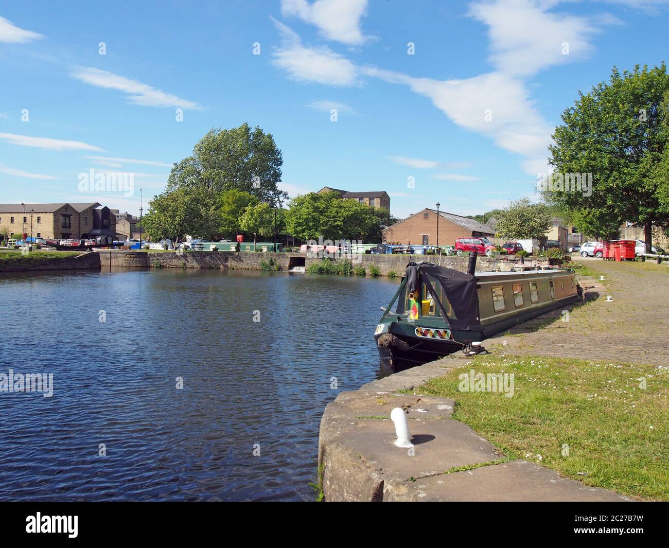 moored houseboats and barges at brighouse basin on the calder and ...