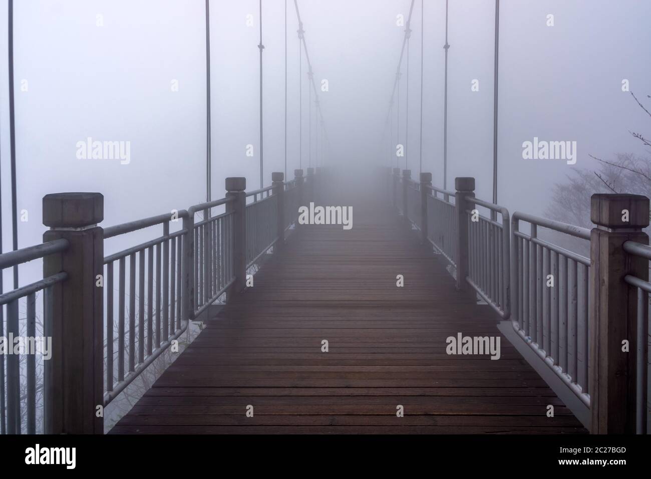 Wooden hanging bridge at Tianmen Mountain vanishing in very heavy mist ...