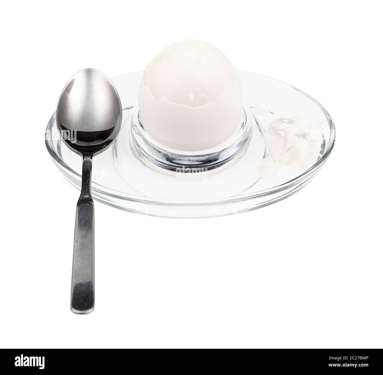 peeled boiled white egg and spoon in glass egg cup isolated on white ...