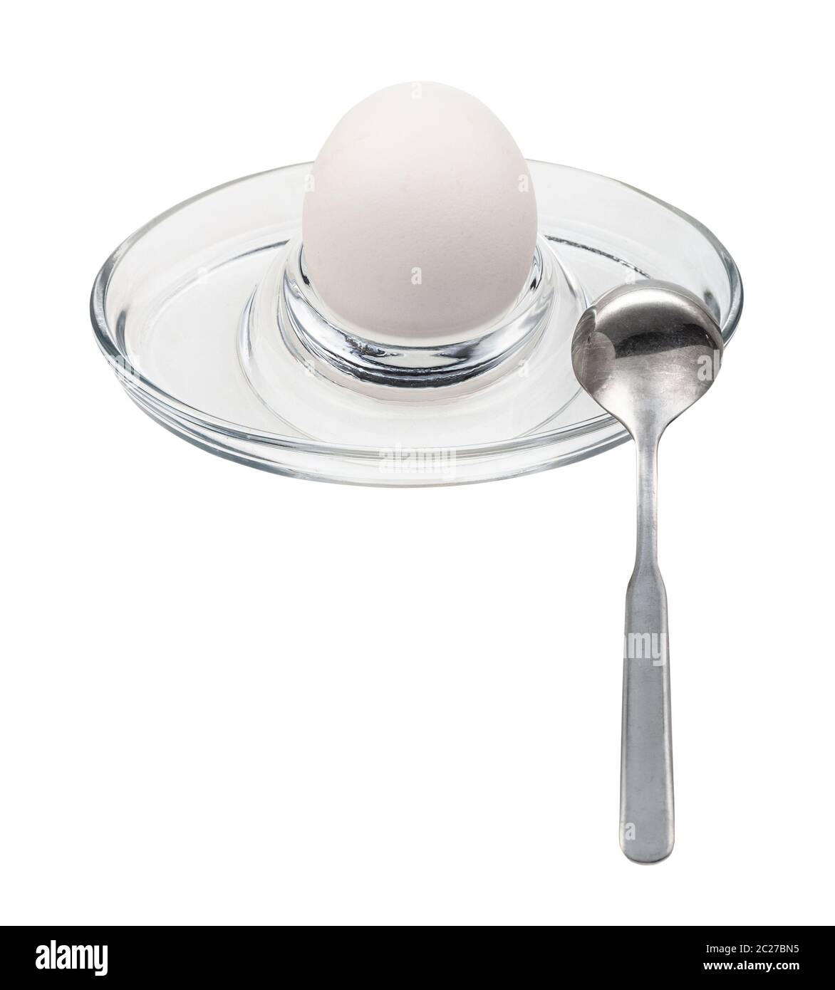 whole boiled white egg and spoon in glass egg cup isolated on white ...