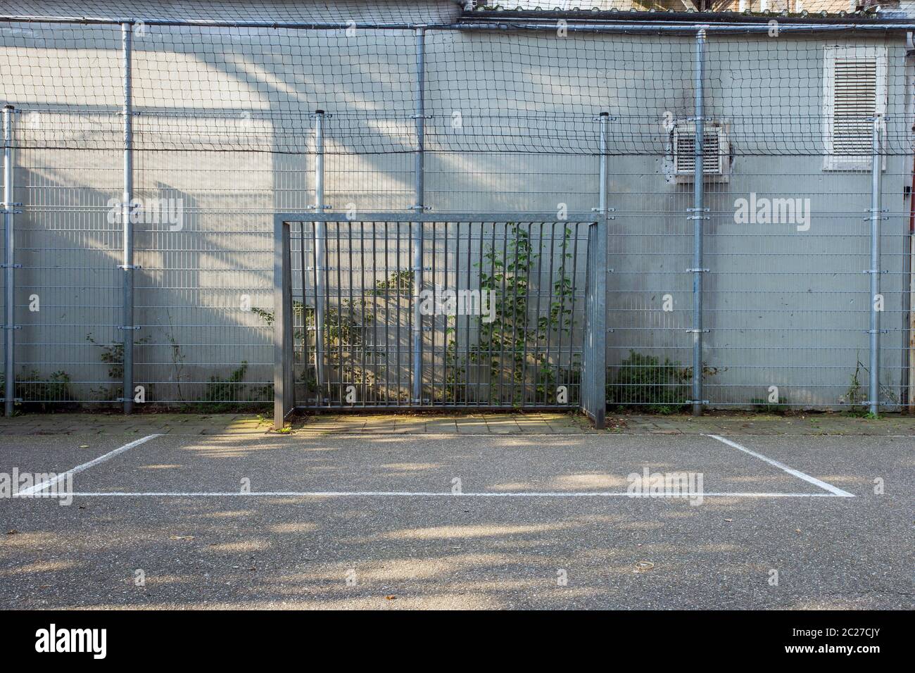 Soccer cage in the city, iron gate protection grid with soccer court ...