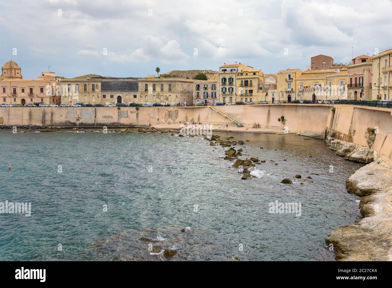 Waterfront with small pebble beach on Ortygia Island in Syracuse ...
