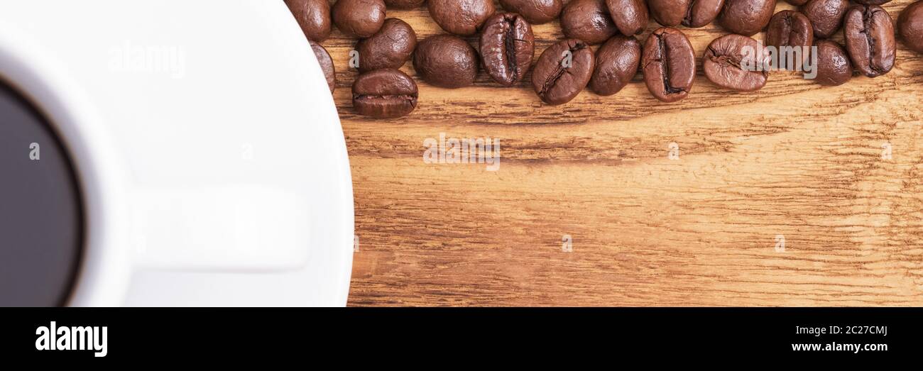 Coffee bean. On the background of wooden boards a cup of coffee and ...