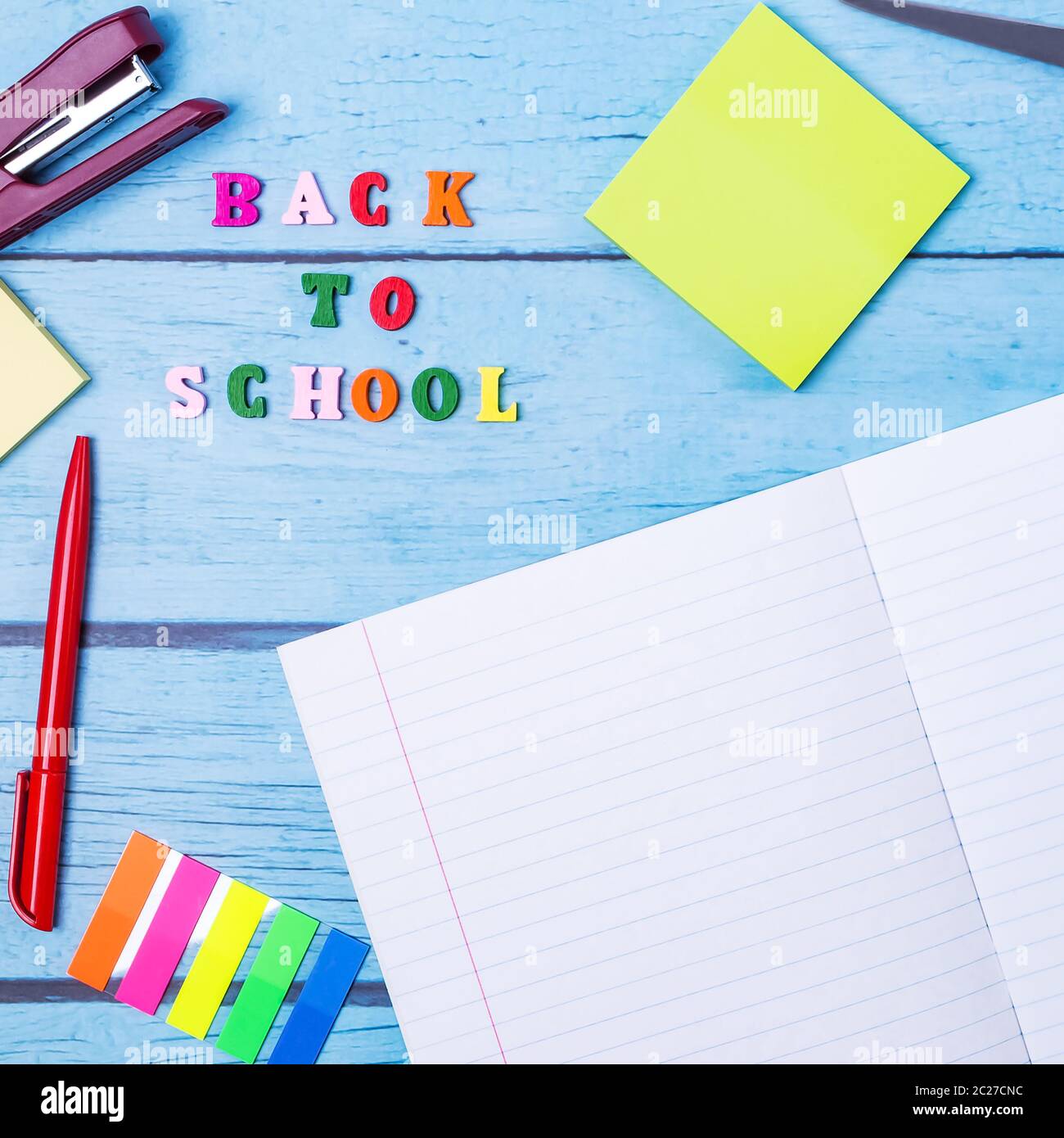 Layout of school supplies on a blue wooden background. The view from ...