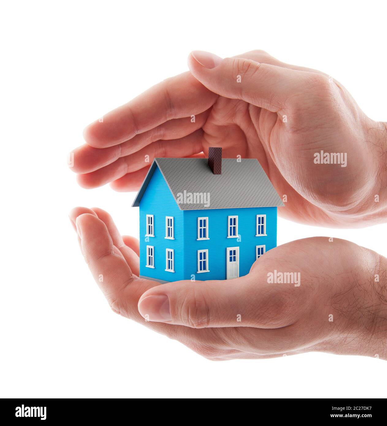 Small blue toy house protected by hands isolated on white Stock Photo ...