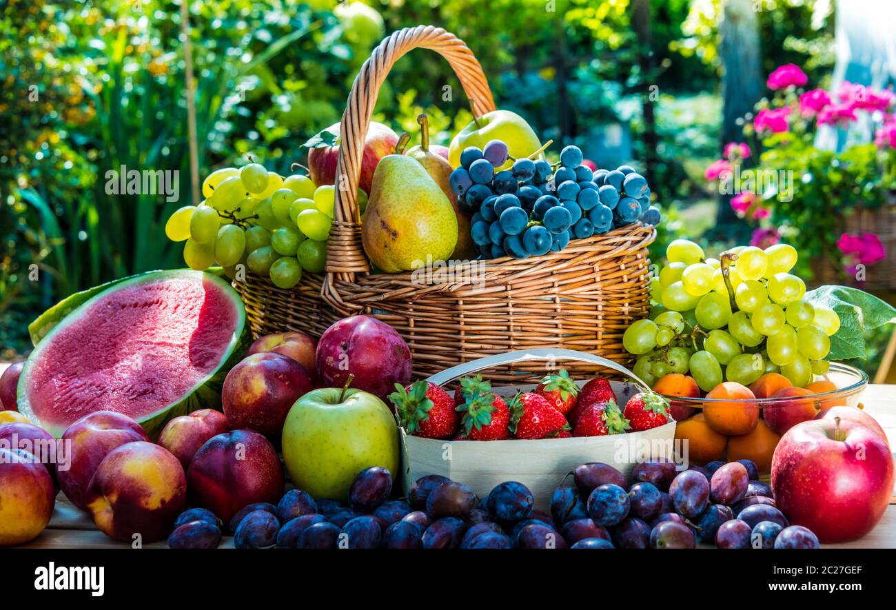Variety of fresh ripe fruits in the garden. Balanced diet Stock Photo ...