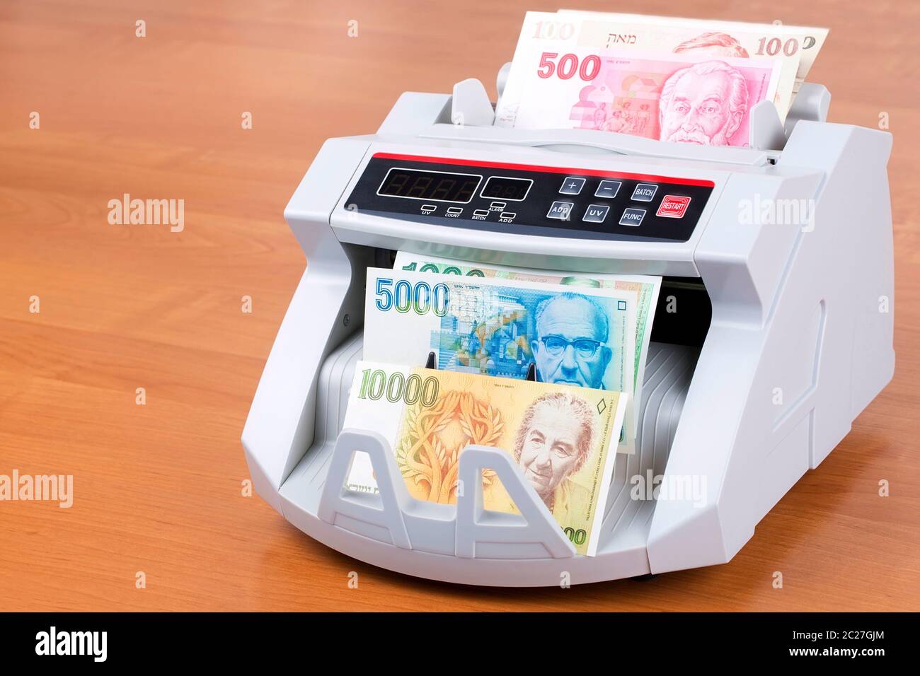 Old money from Israel in a counting machine Stock Photo - Alamy