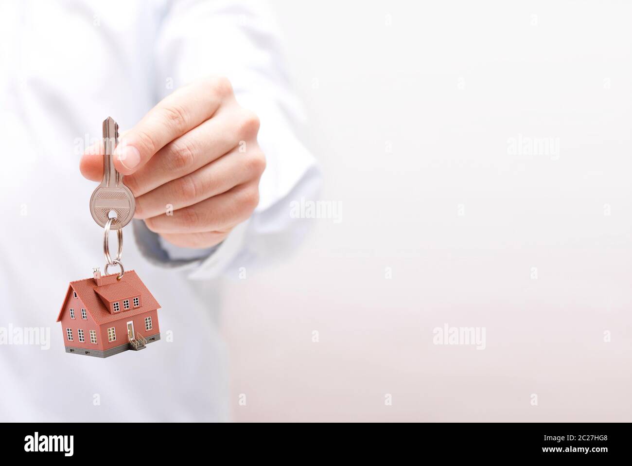House key in hand Stock Photo - Alamy