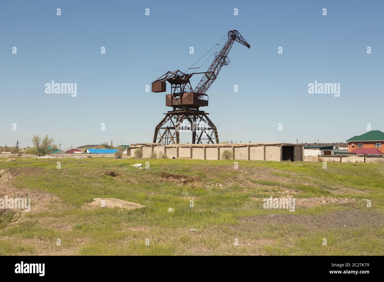 Port crane in an abandoned fishing port on the dried Aral sea Stock ...