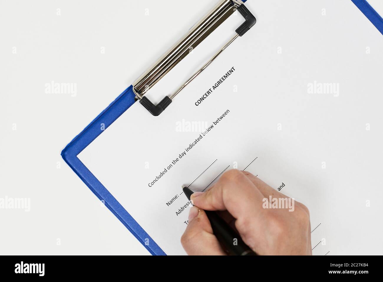 A person hand filling and signing concert agreement Stock Photo - Alamy