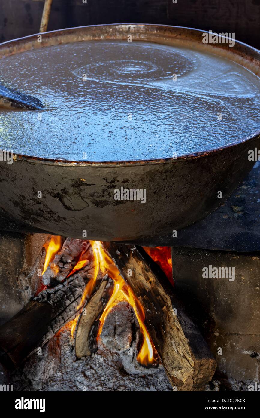 Old wood burning stove with big pan preparing beans Stock Photo - Alamy