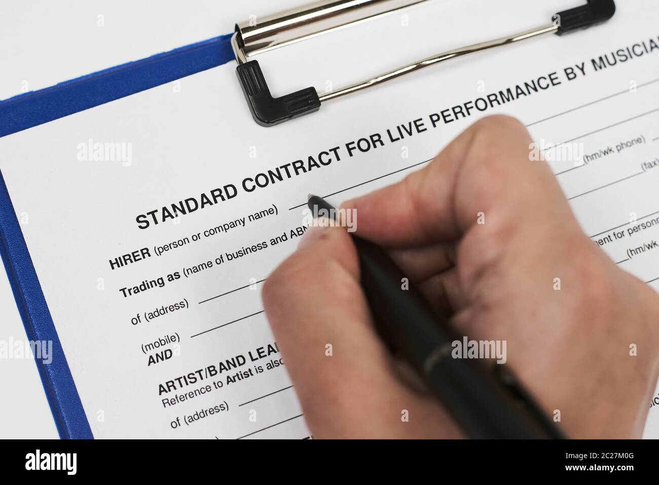 Signing standart contract for live performance by musicians. A musician ...