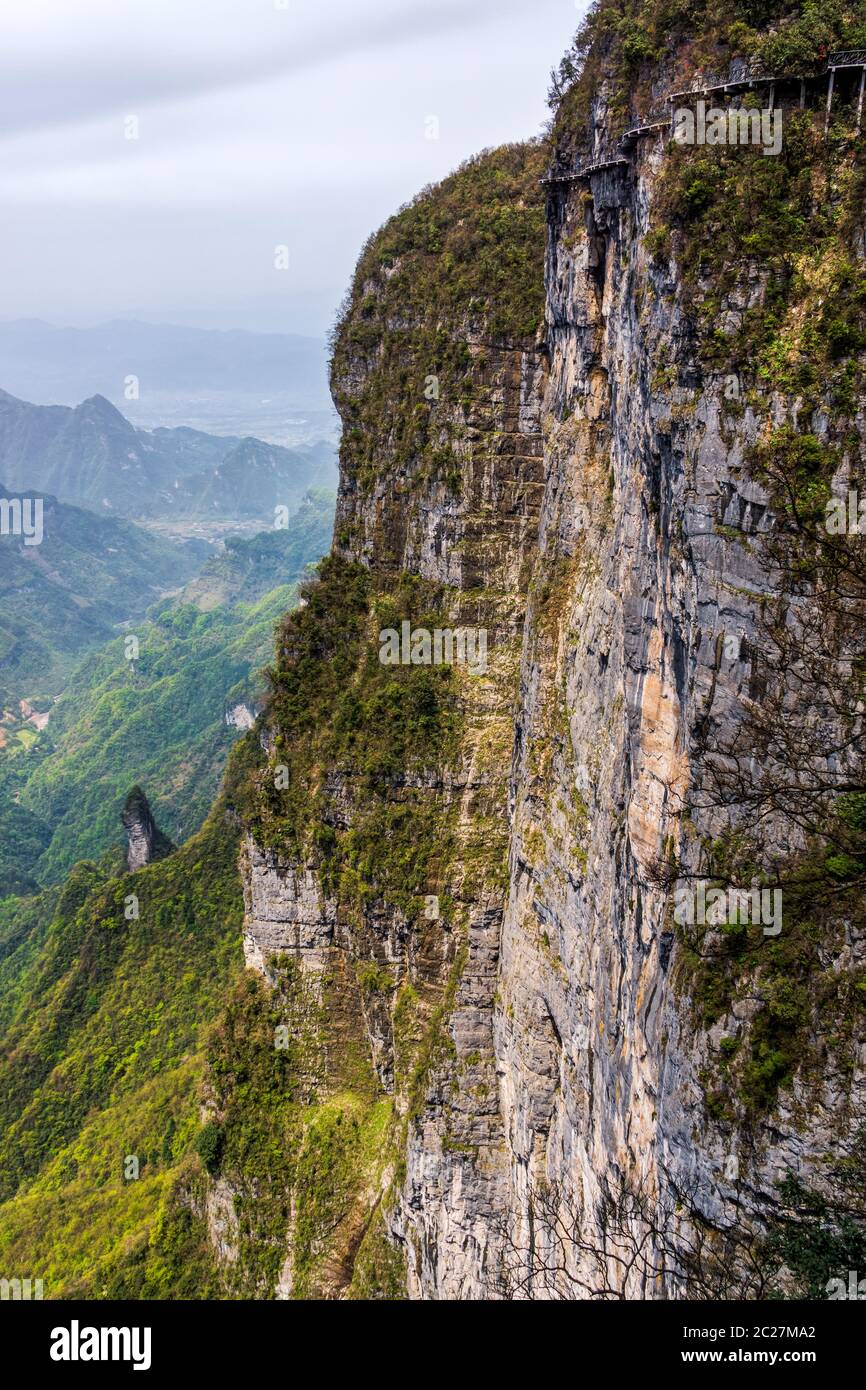 Tourists walking on the Sky Walk at Tianmen Mountain, very high cliff ...