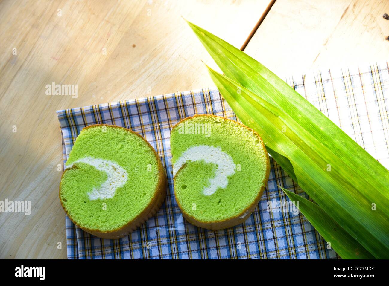 Pandan cream roll cake bakery pastry on fabric with cream and fresh ...