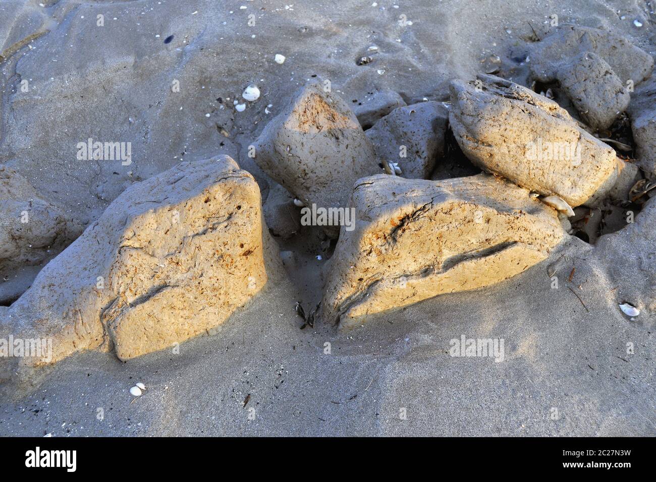 Sand structure with stones on the beach Stock Photo - Alamy