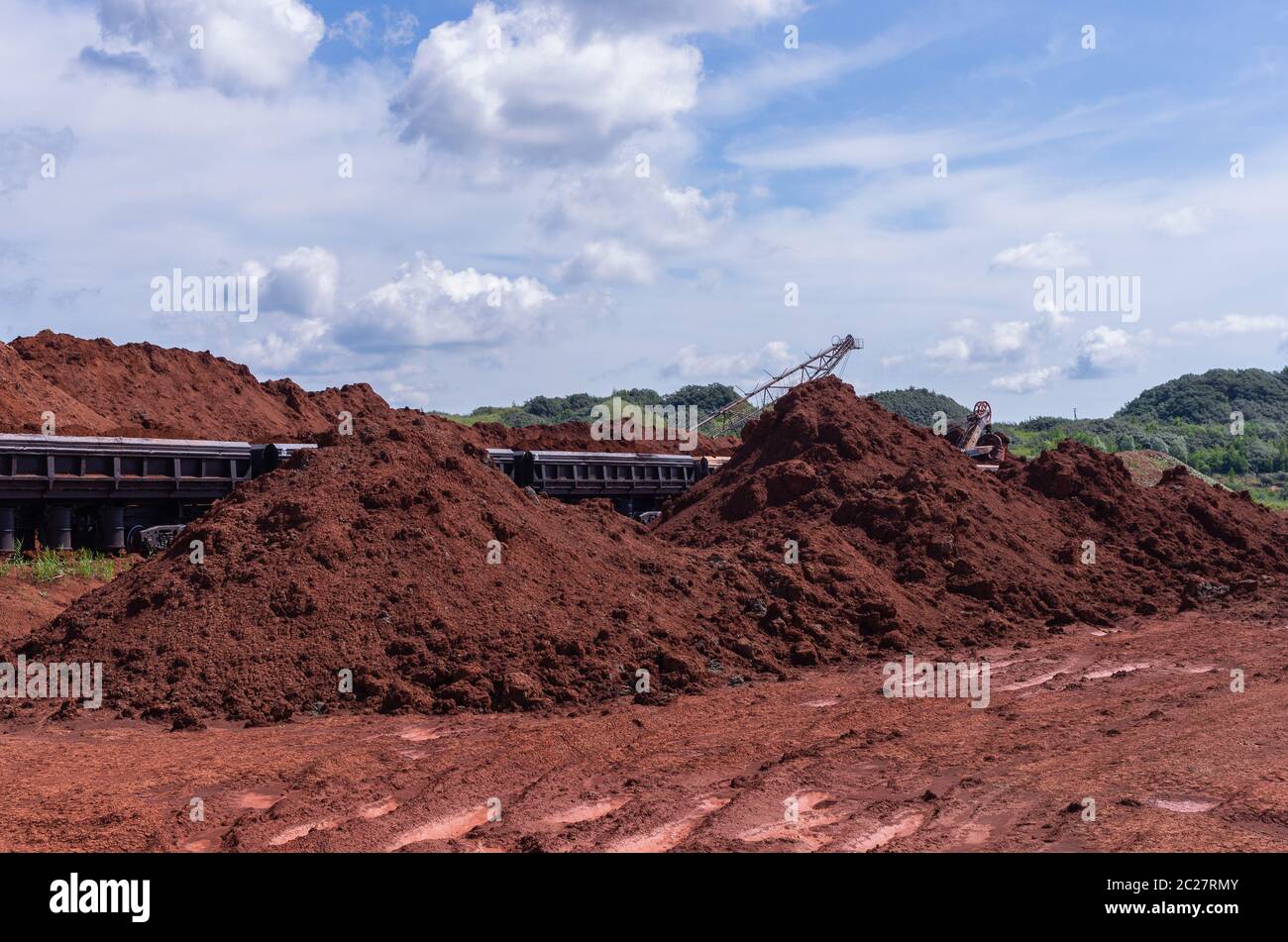 Excavator loading clay to the train Stock Photo - Alamy