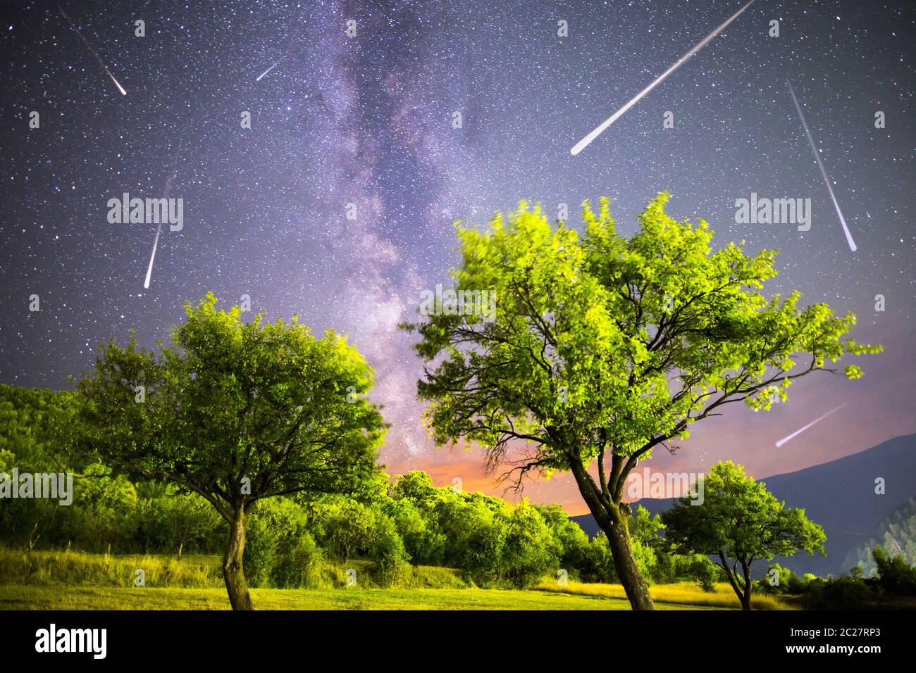 Green trees Milky way night sky falling stars Stock Photo - Alamy