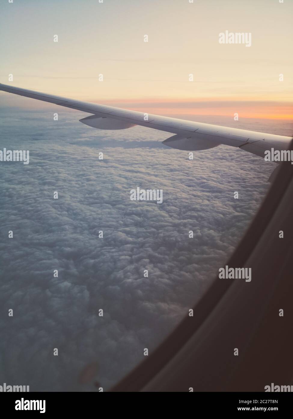 Color close up shot of the window of a passenger airplane, flying above ...