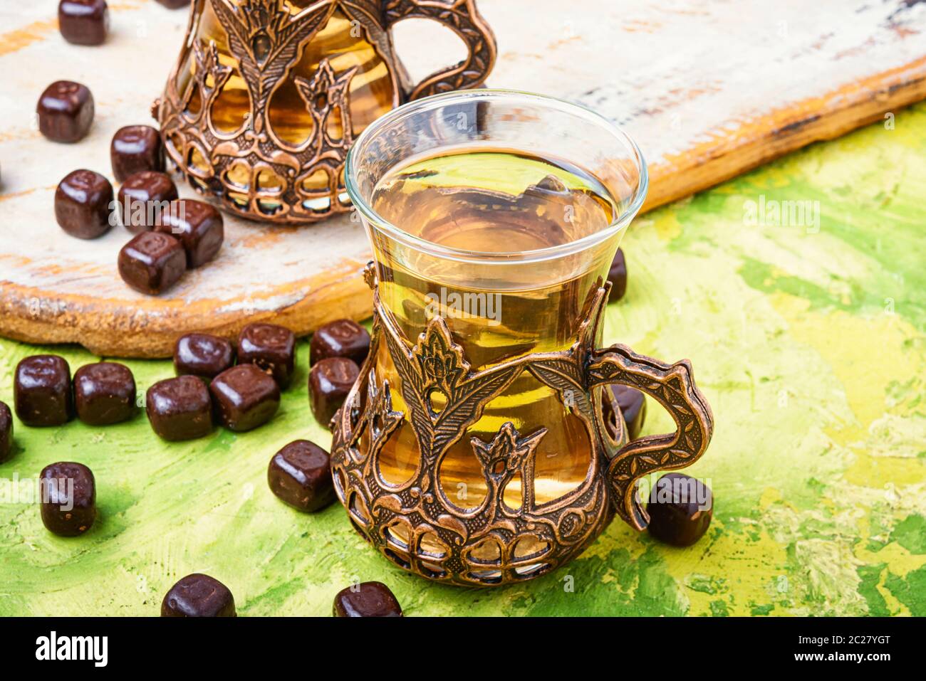 Eastern tea concept.Eastern tea in traditional glass with chocolate ...
