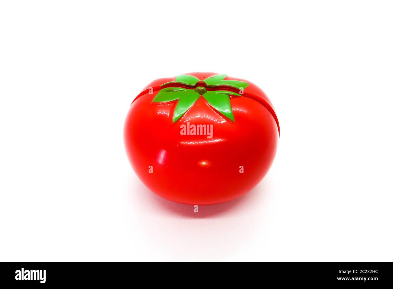 dark red tomato toy isolated on white background Stock Photo - Alamy