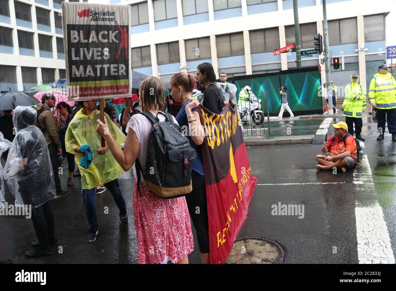 Pictured: Protesters stop outside the Redfern Police station and hold a ...
