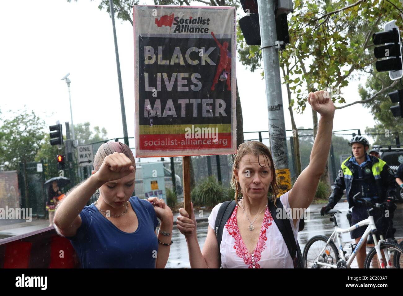 Pictured: Protesters stop outside the Redfern Police station and hold a ...
