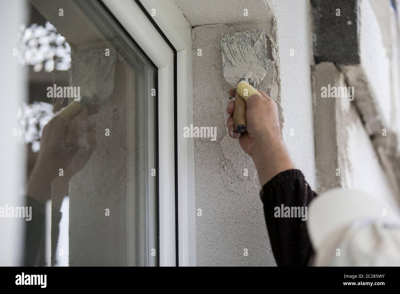 Plastering arm hi-res stock photography and images - Alamy