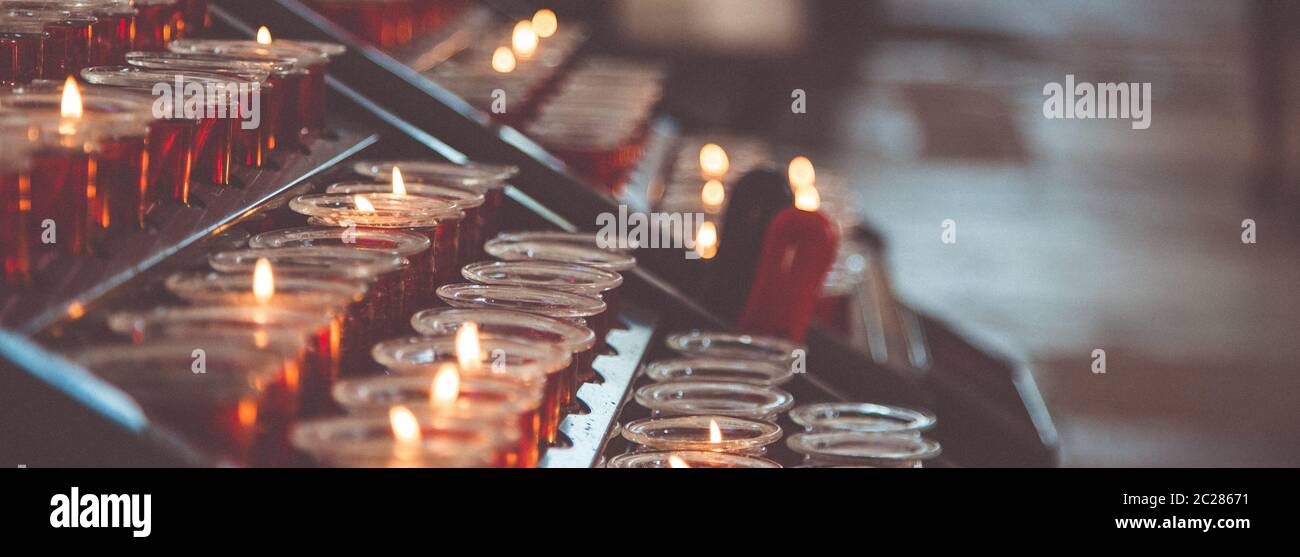 Candles in the Church. Votive prayer candles inside a catholic church ...
