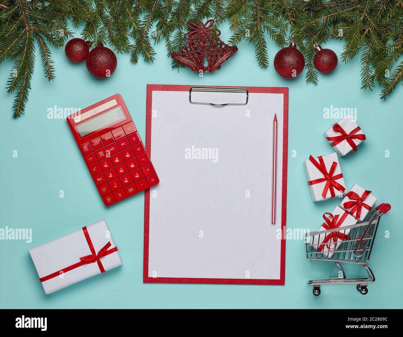 Shopping trolley with gift boxes, clipboard with blank sheet and fir ...